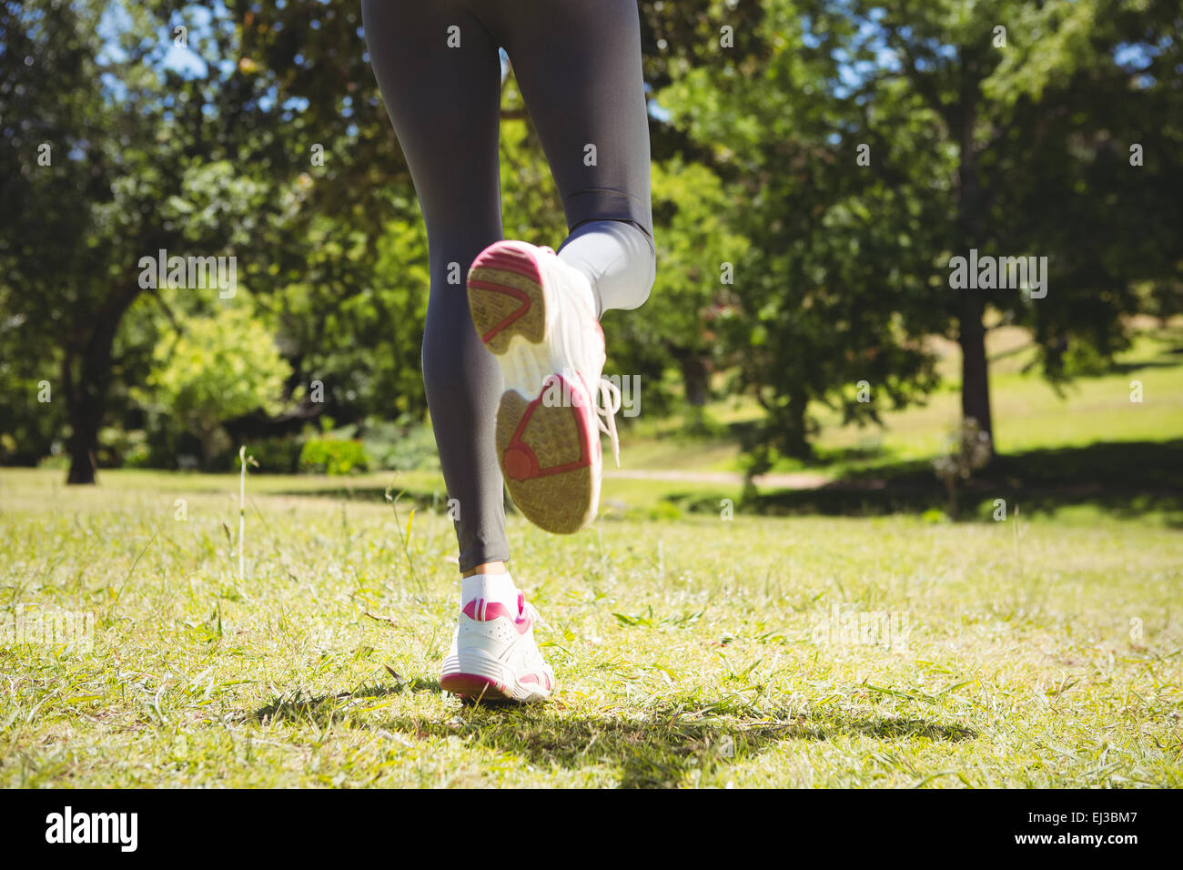 Fit woman taking a step Stock Photo - Alamy