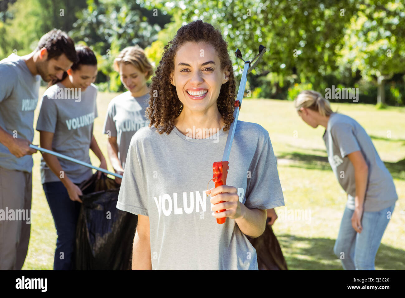 Team of volunteers picking up trash Stock Photo - Alamy