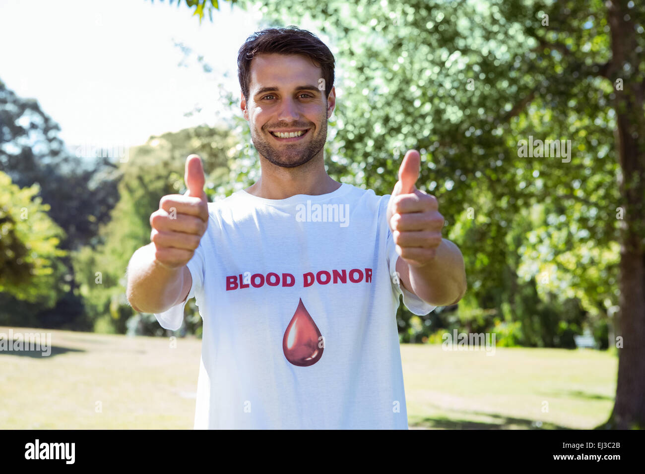 Blood donor smiling at camera Stock Photo - Alamy
