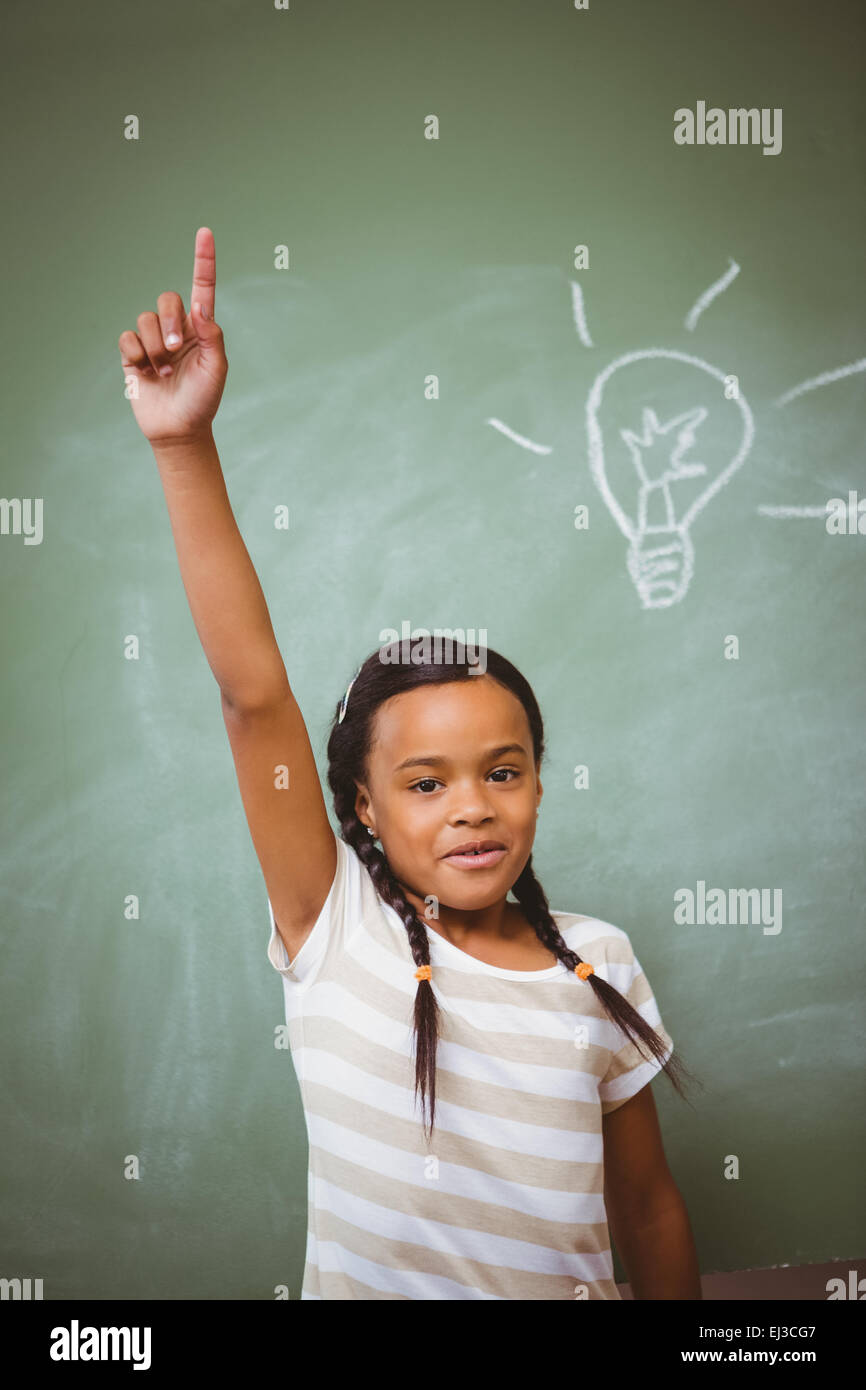 Little girl raising hand in classroom Stock Photo - Alamy