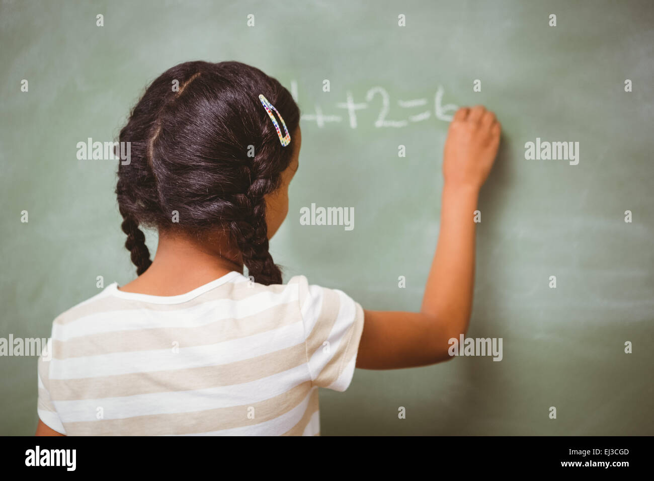 Rear view of little girl writing on blackboard Stock Photo - Alamy