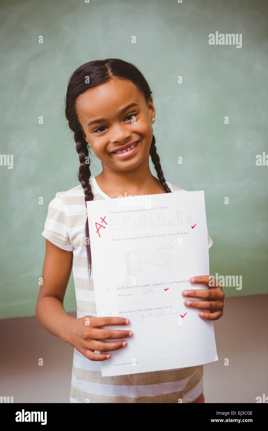 Portrait of cute little girl holding paper Stock Photo - Alamy