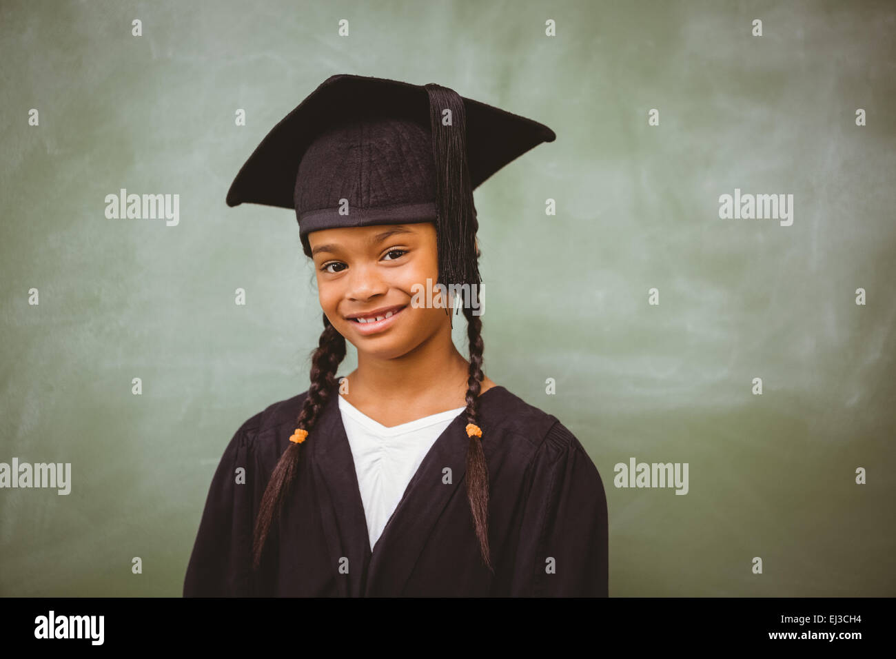 Little girl wearing graduation robe Stock Photo - Alamy