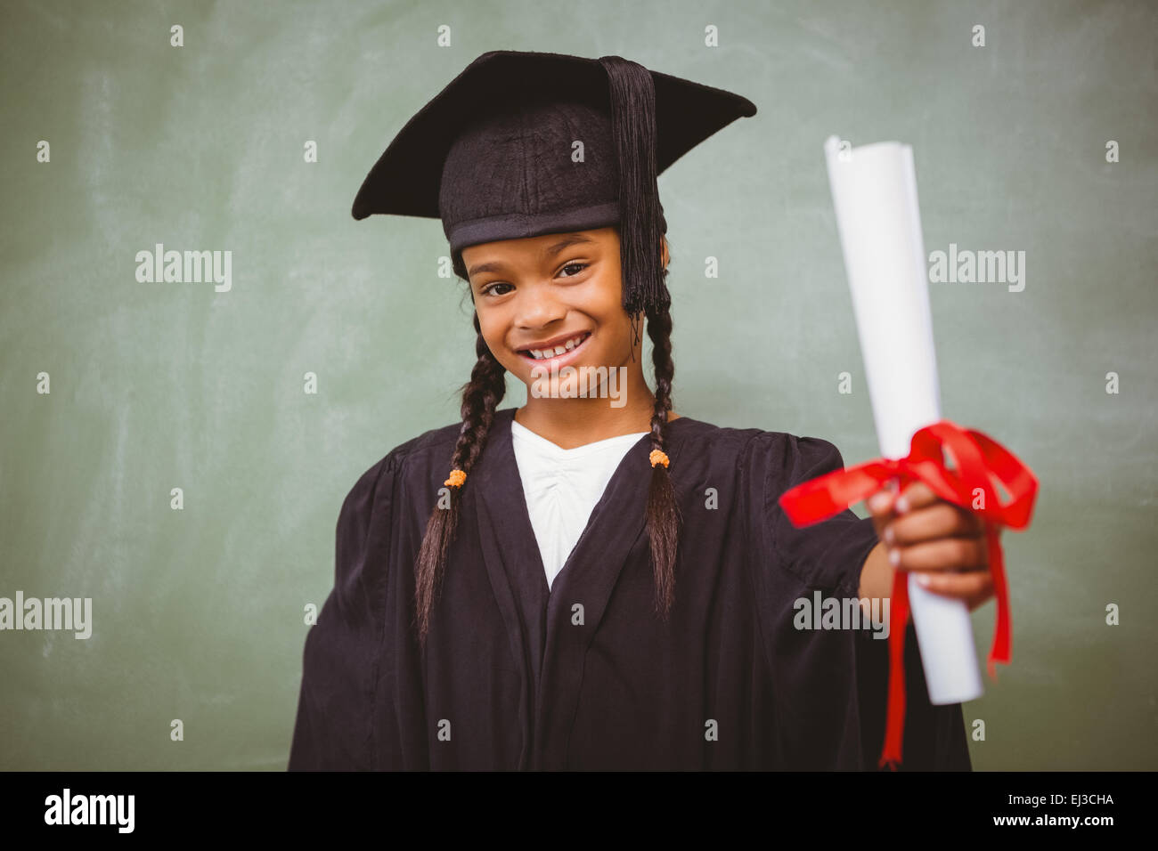 Little girl in graduation robe holding diploma Stock Photo - Alamy