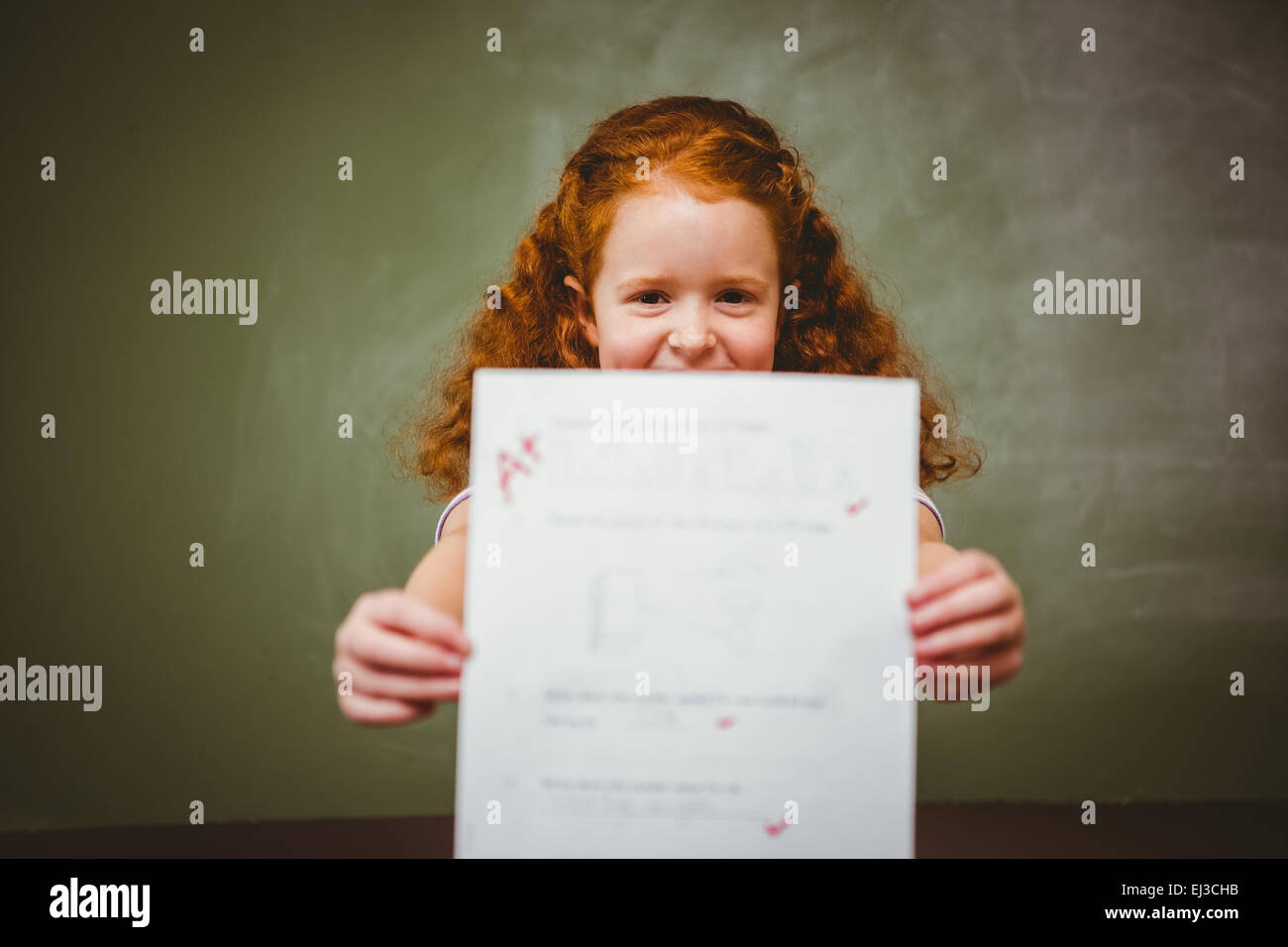 Portrait of cute little girl holding paper Stock Photo - Alamy