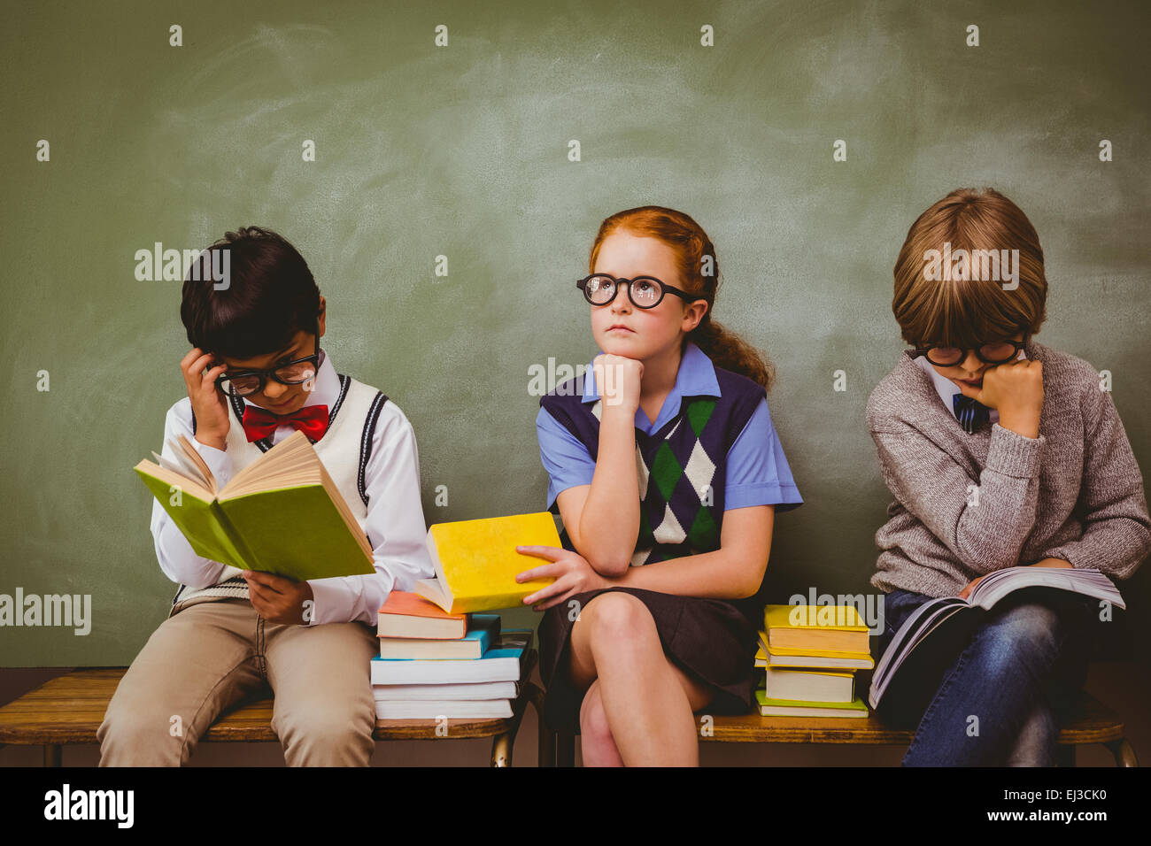 Kids with stack of books in classroom Stock Photo - Alamy
