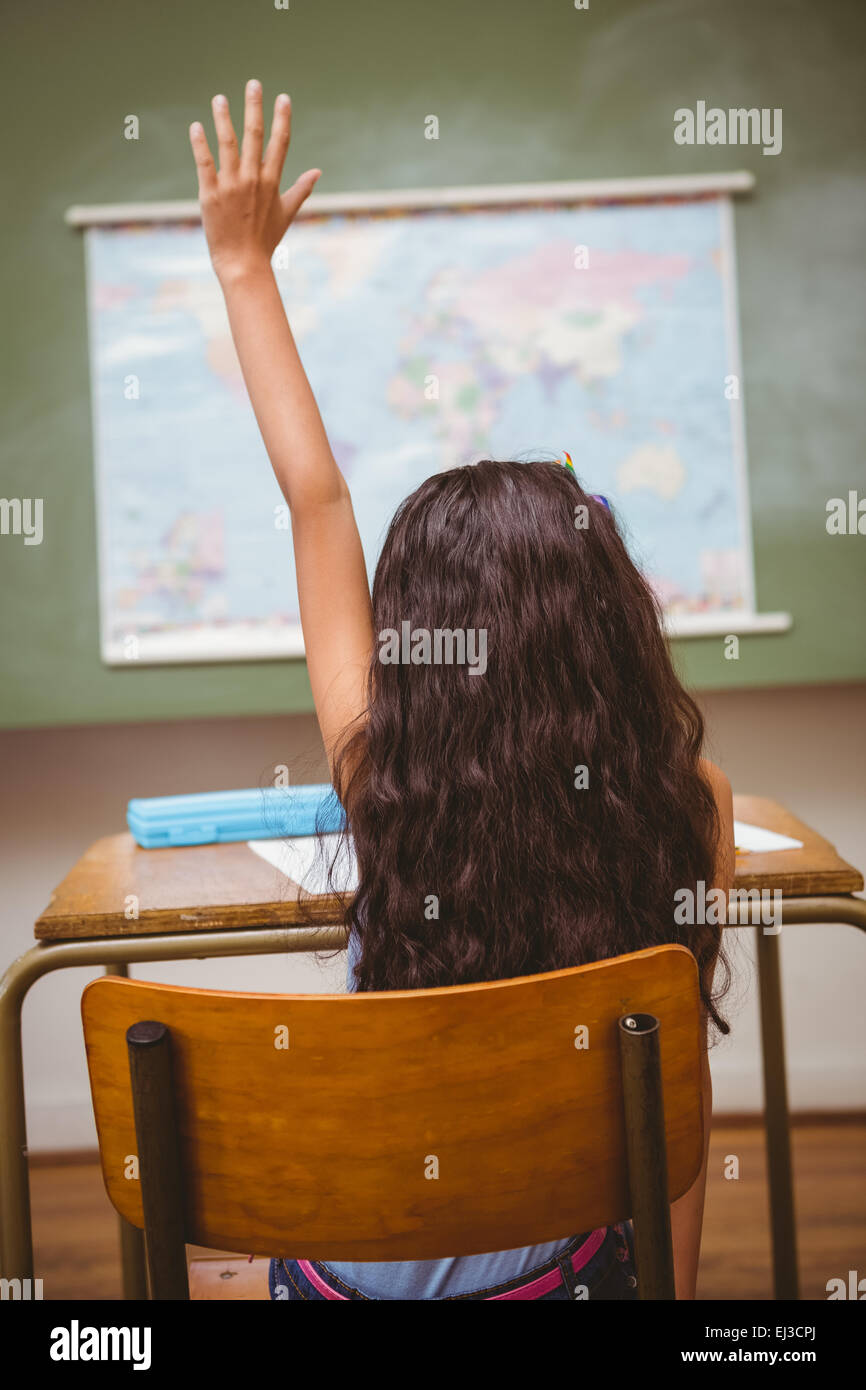Little girl raising hand in classroom Stock Photo - Alamy