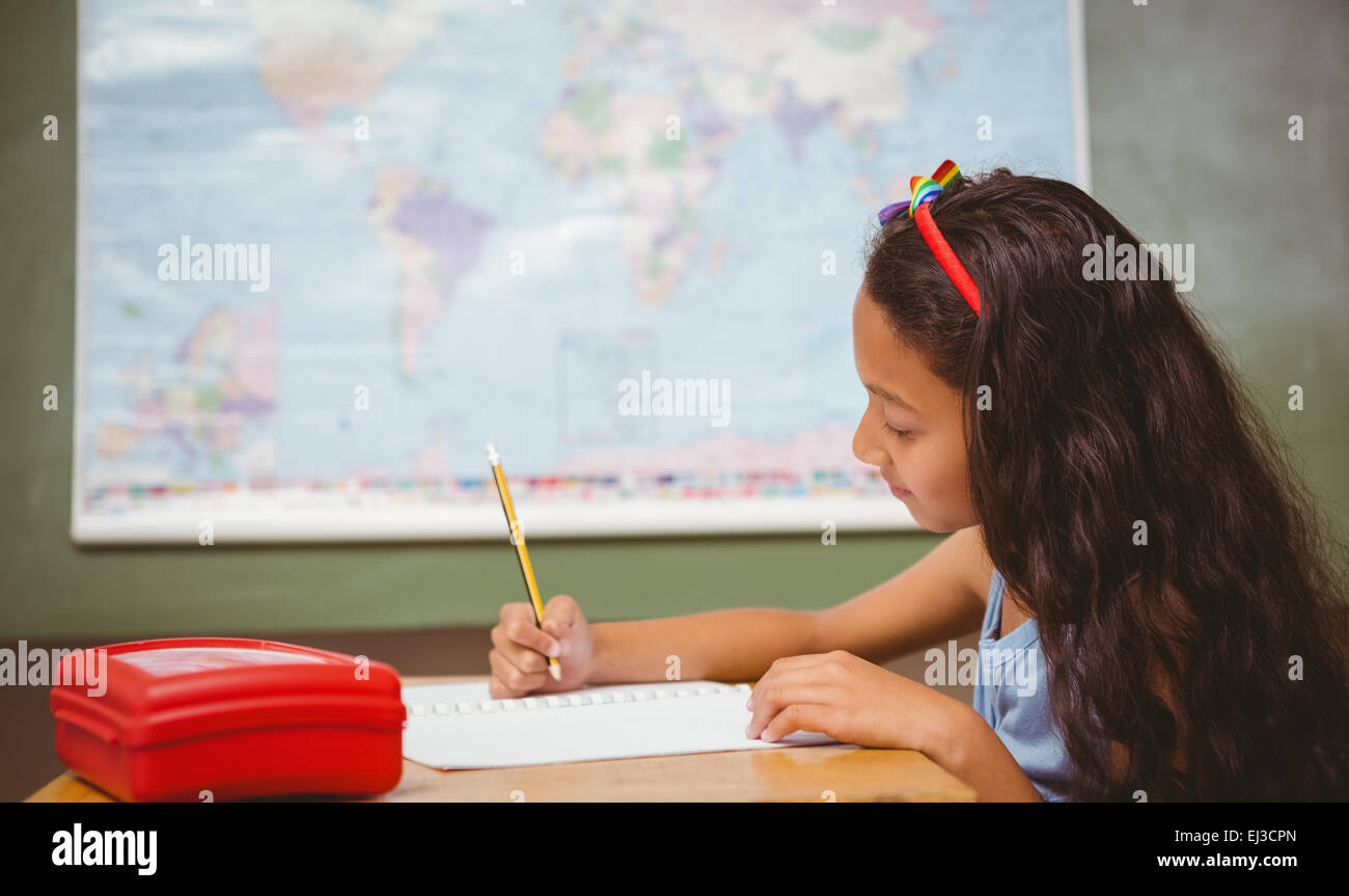 Little girl writing book in classroom Stock Photo - Alamy