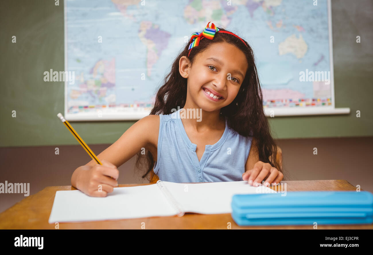 Little girl writing book in classroom Stock Photo - Alamy