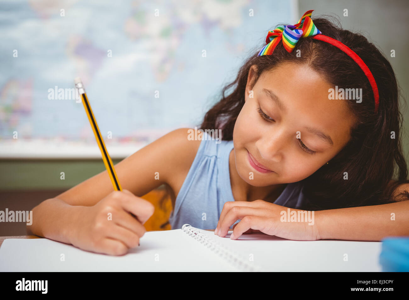 Little girl writing book in classroom Stock Photo - Alamy