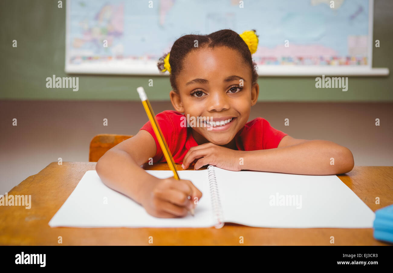 Little girl writing book in classroom Stock Photo - Alamy
