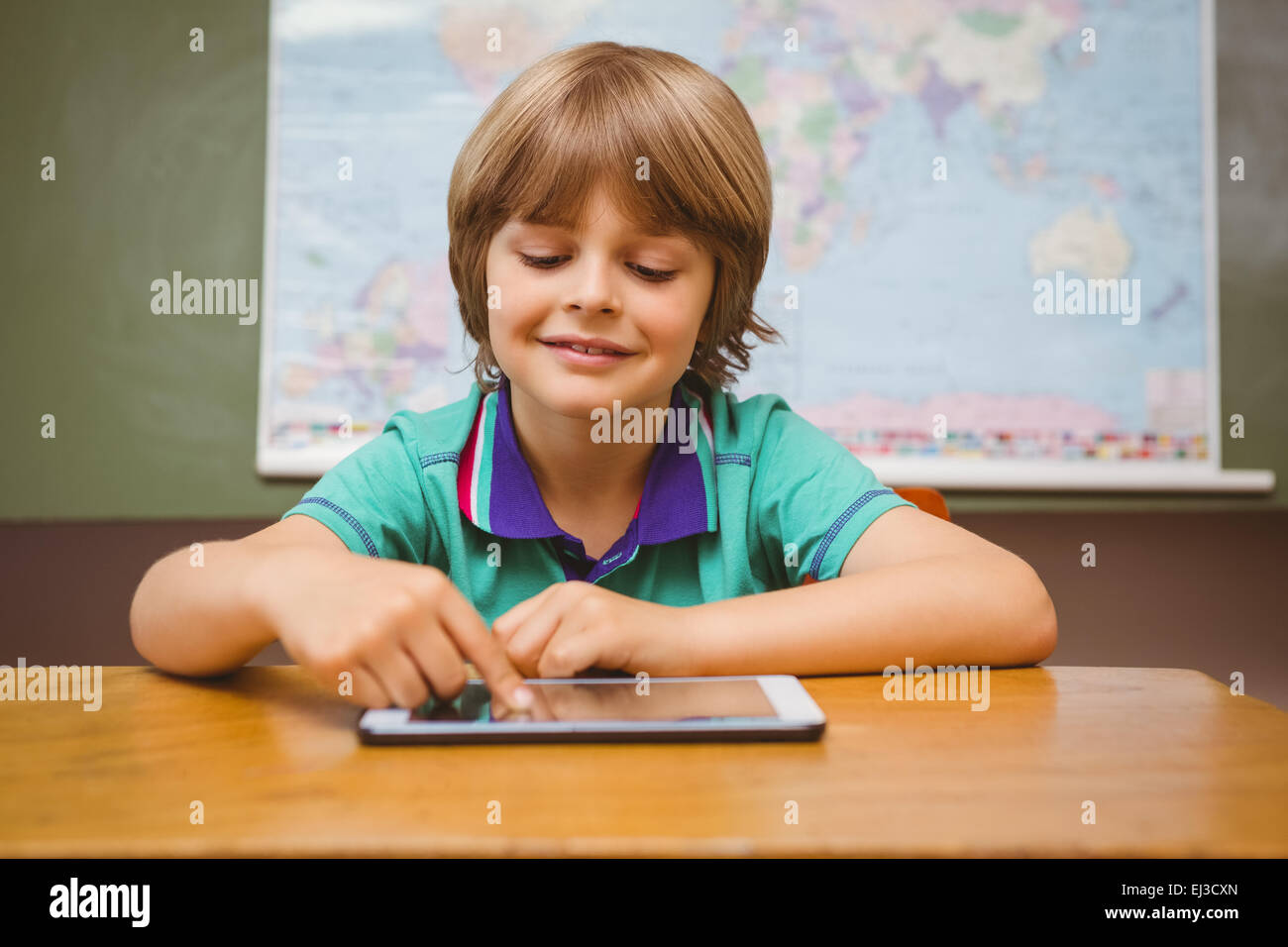 Little boy using digital tablet in classroom Stock Photo - Alamy