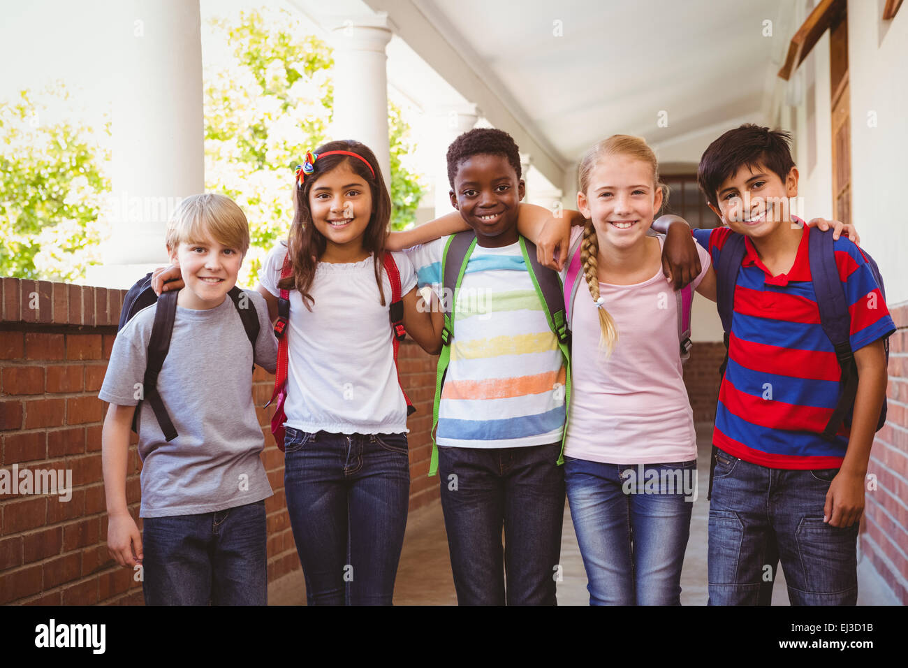Smiling little school kids in school corridor Stock Photo - Alamy
