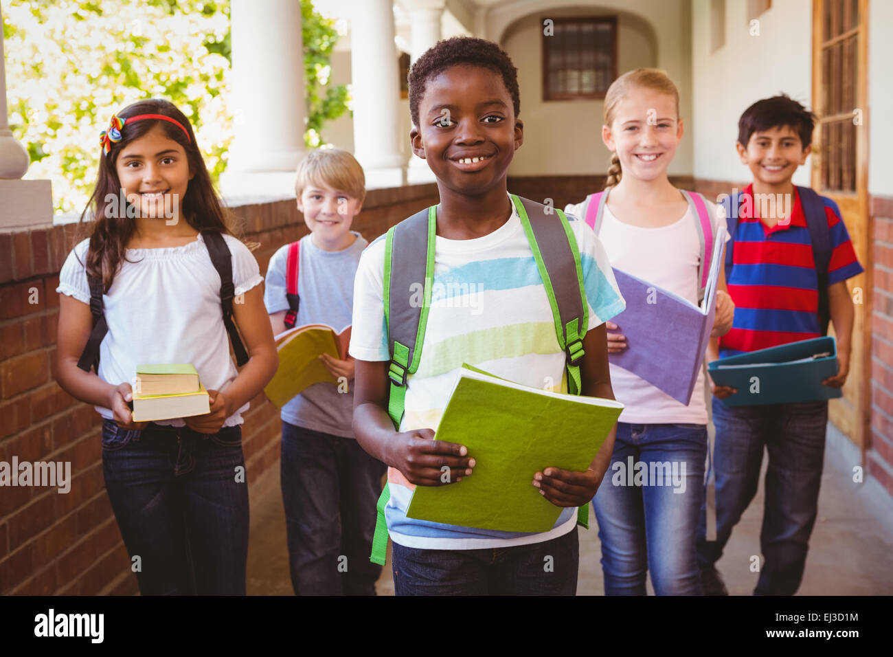 Smiling little school kids in school corridor Stock Photo - Alamy
