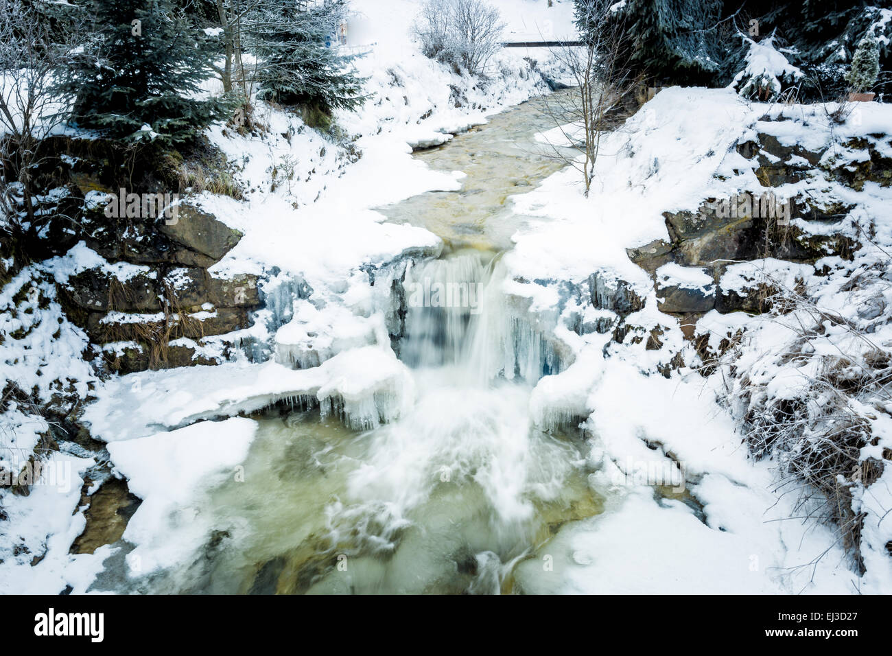 Fast river with waterfall in Austrian Alps at snowy day Stock Photo - Alamy