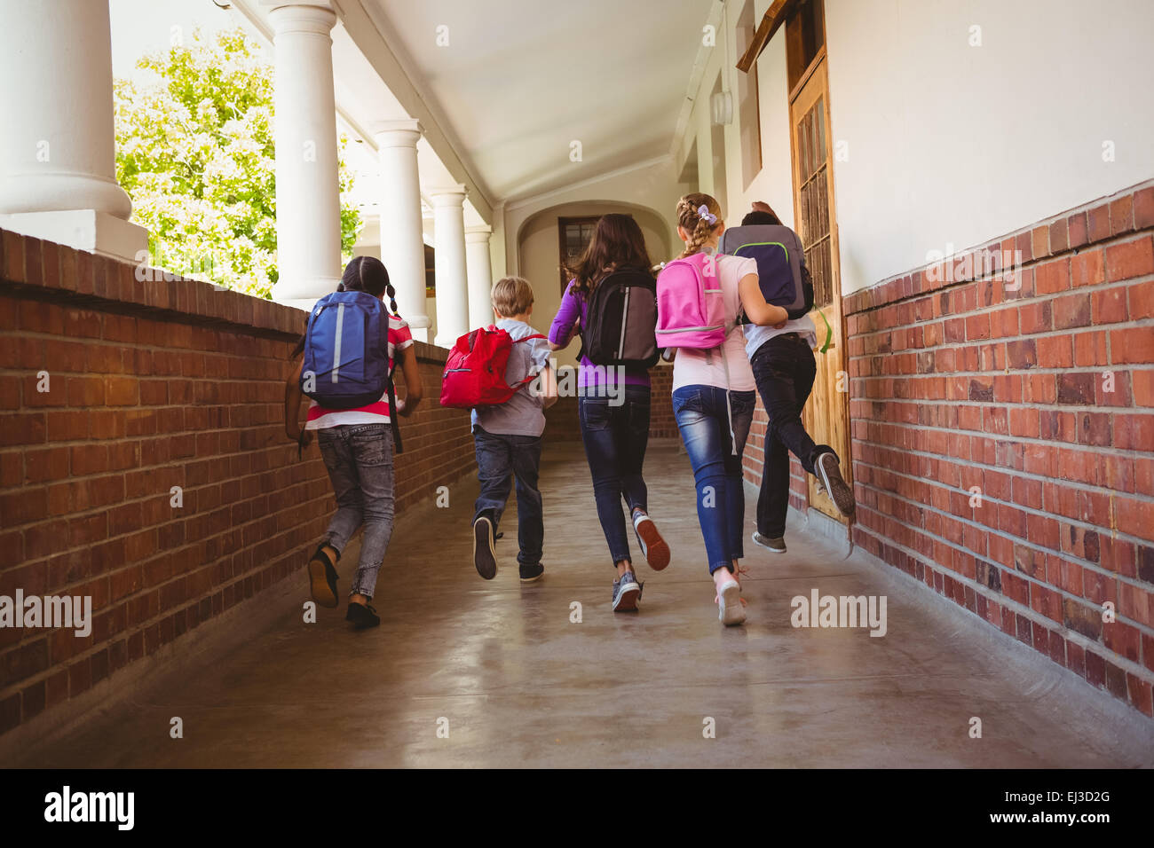 School kids running in school corridor Stock Photo - Alamy