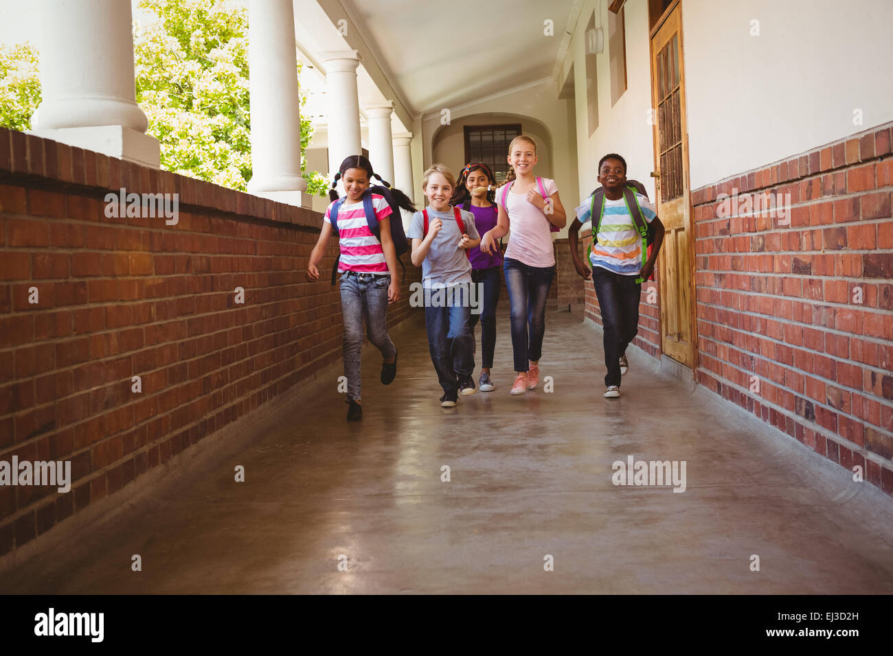 School kids running in school corridor Stock Photo - Alamy