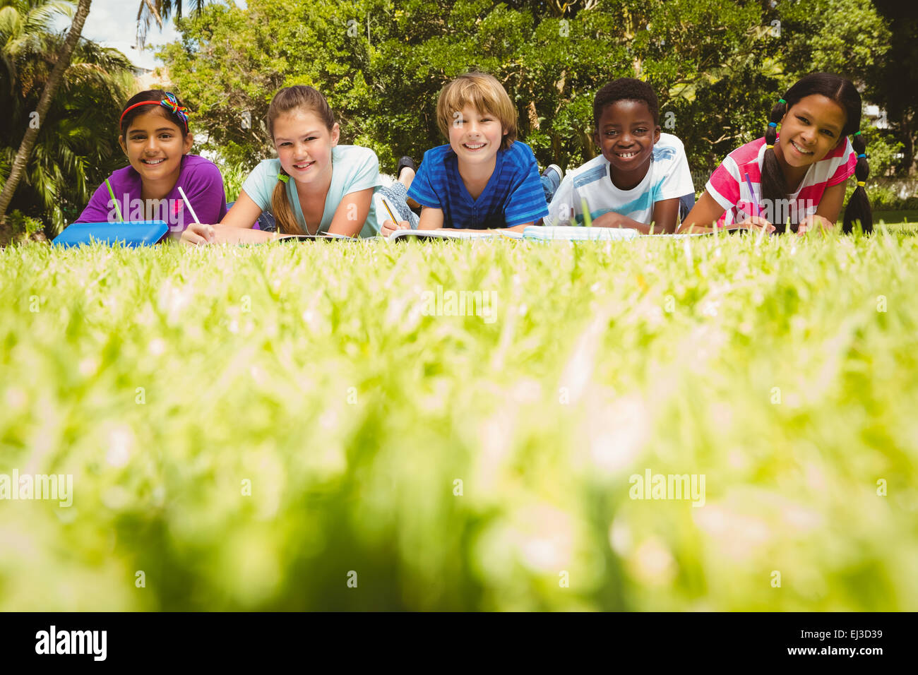Children doing homework at park Stock Photo - Alamy