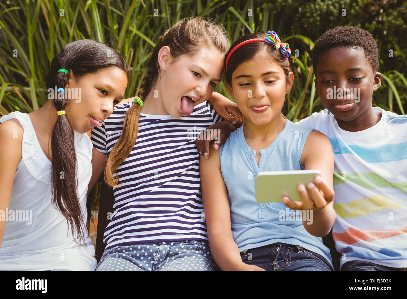 Happy children taking selfie at park Stock Photo - Alamy