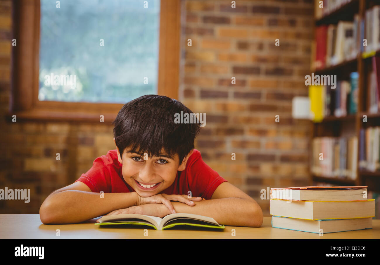 Portrait of boy reading book in library Stock Photo - Alamy