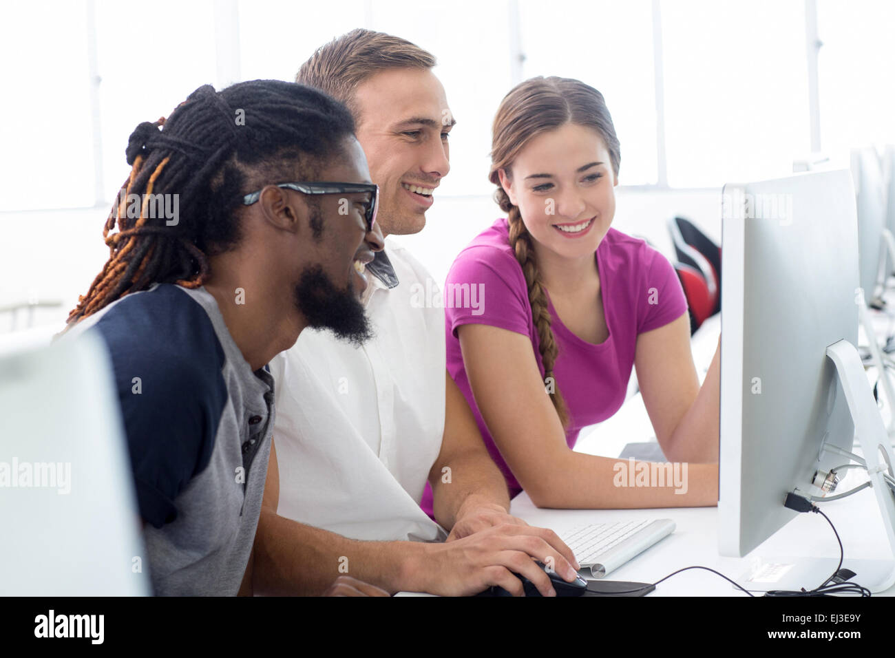 Smiling students in computer class Stock Photo - Alamy
