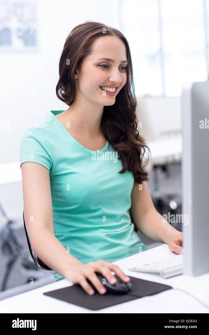 Smiling female student in computer class Stock Photo - Alamy