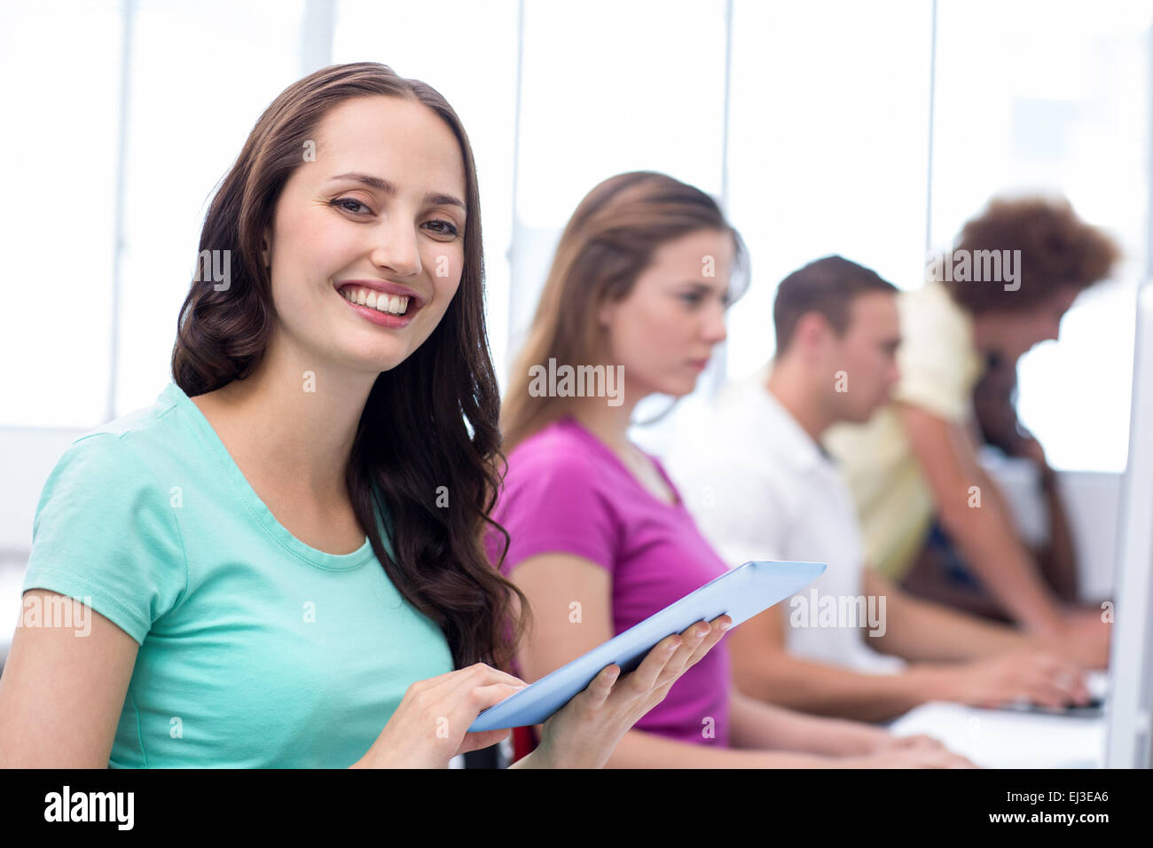 Student smiling at camera in computer class Stock Photo - Alamy