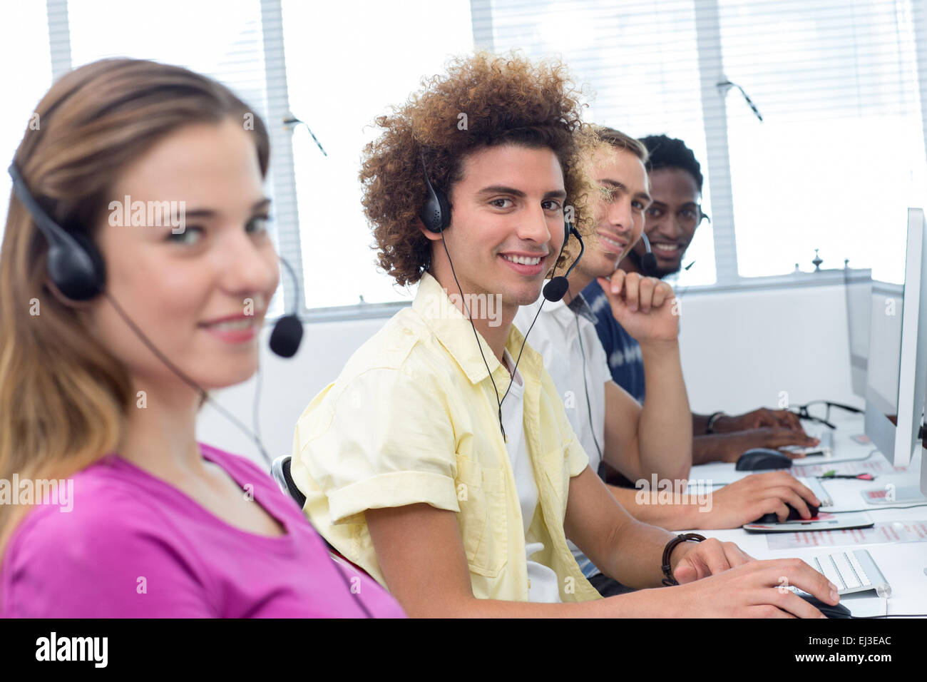 Smiling students using headsets in computer class Stock Photo - Alamy