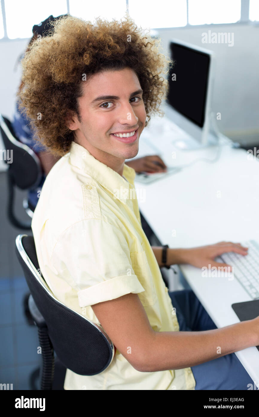 Student smiling at camera in computer class Stock Photo - Alamy