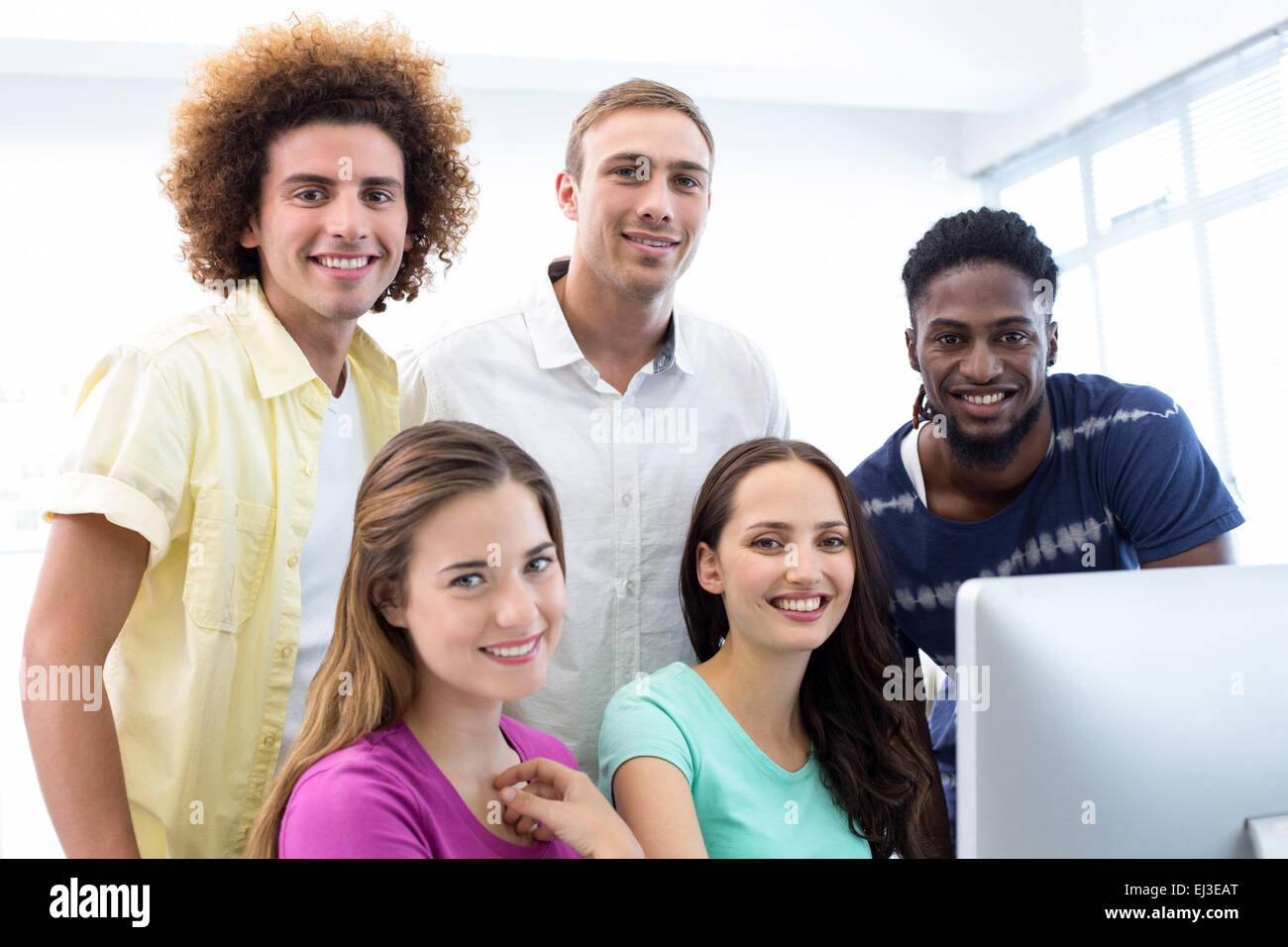Smiling students in computer class Stock Photo - Alamy