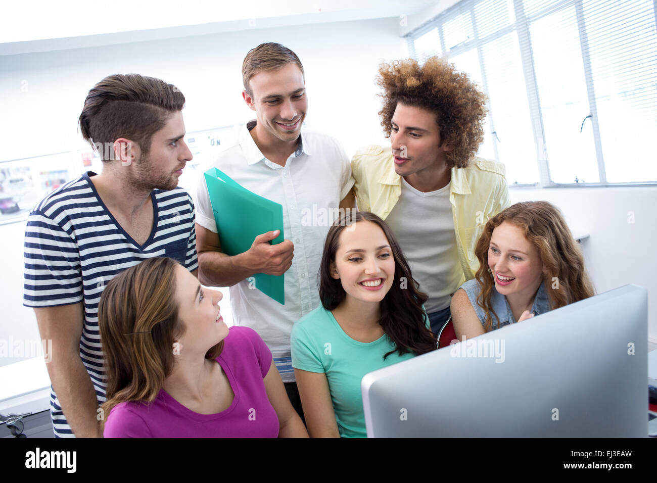 Smiling students in computer class Stock Photo - Alamy