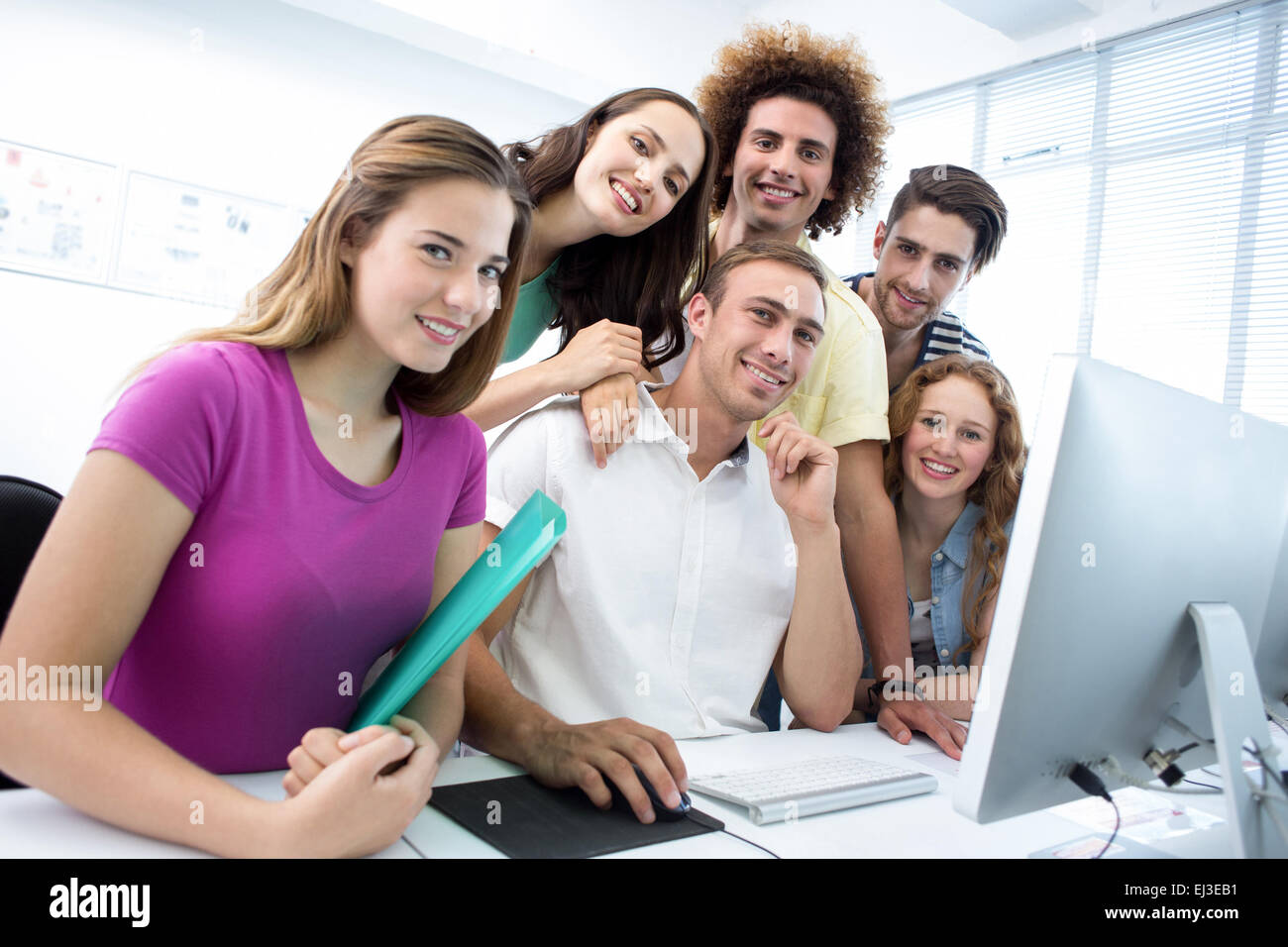 Smiling students in computer class Stock Photo - Alamy