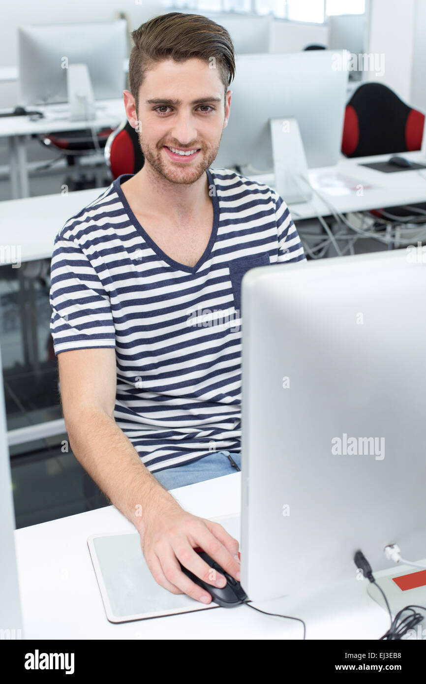 Smiling male student in computer class Stock Photo - Alamy