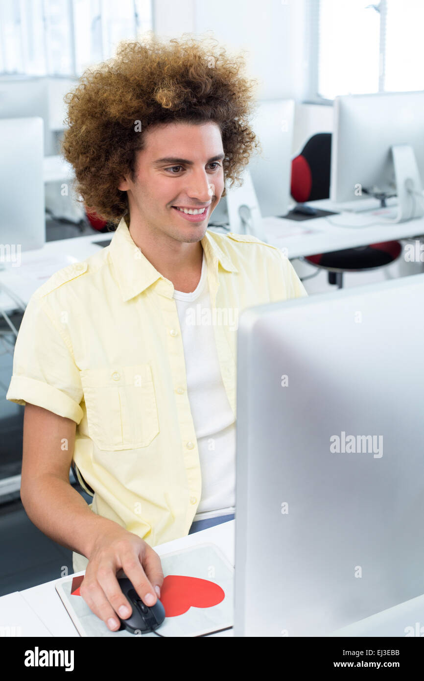 Smiling male student in computer class Stock Photo - Alamy