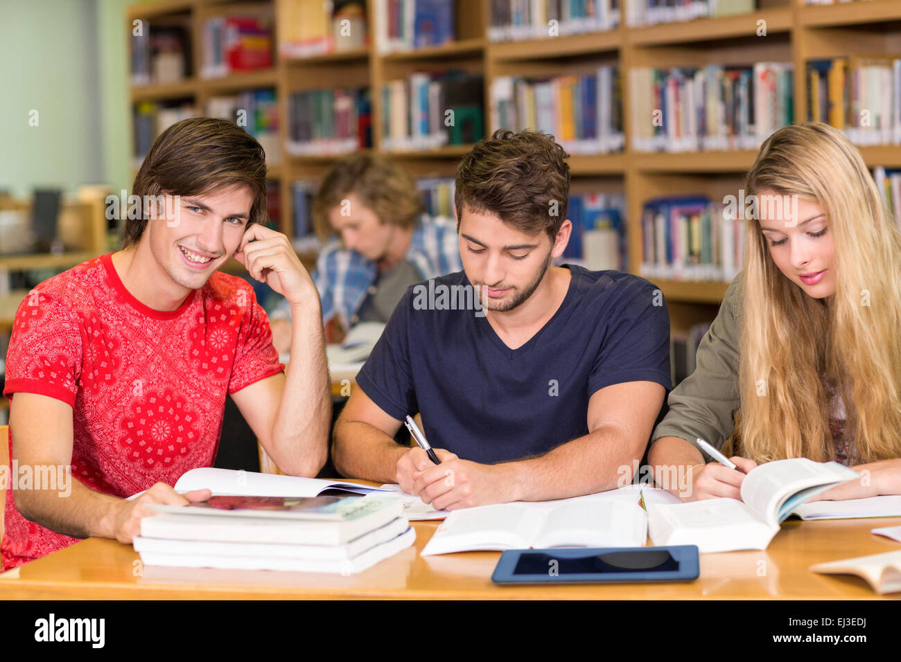 College students doing homework in library Stock Photo - Alamy