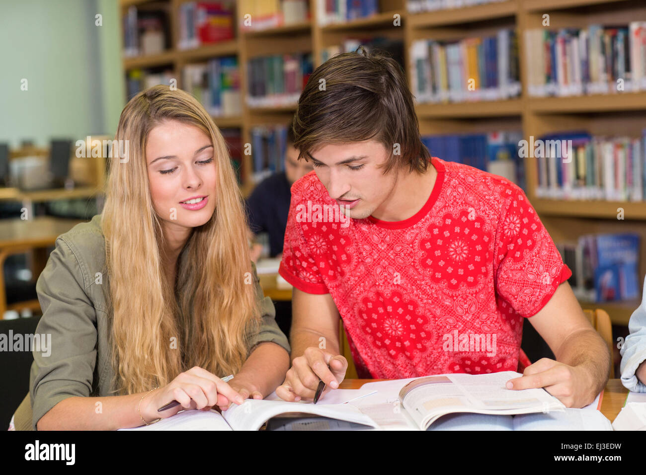 College students doing homework in library Stock Photo - Alamy