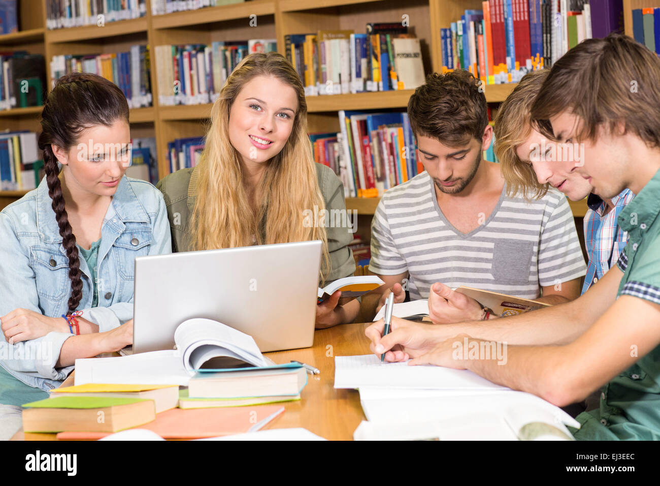 College students doing homework in library Stock Photo - Alamy