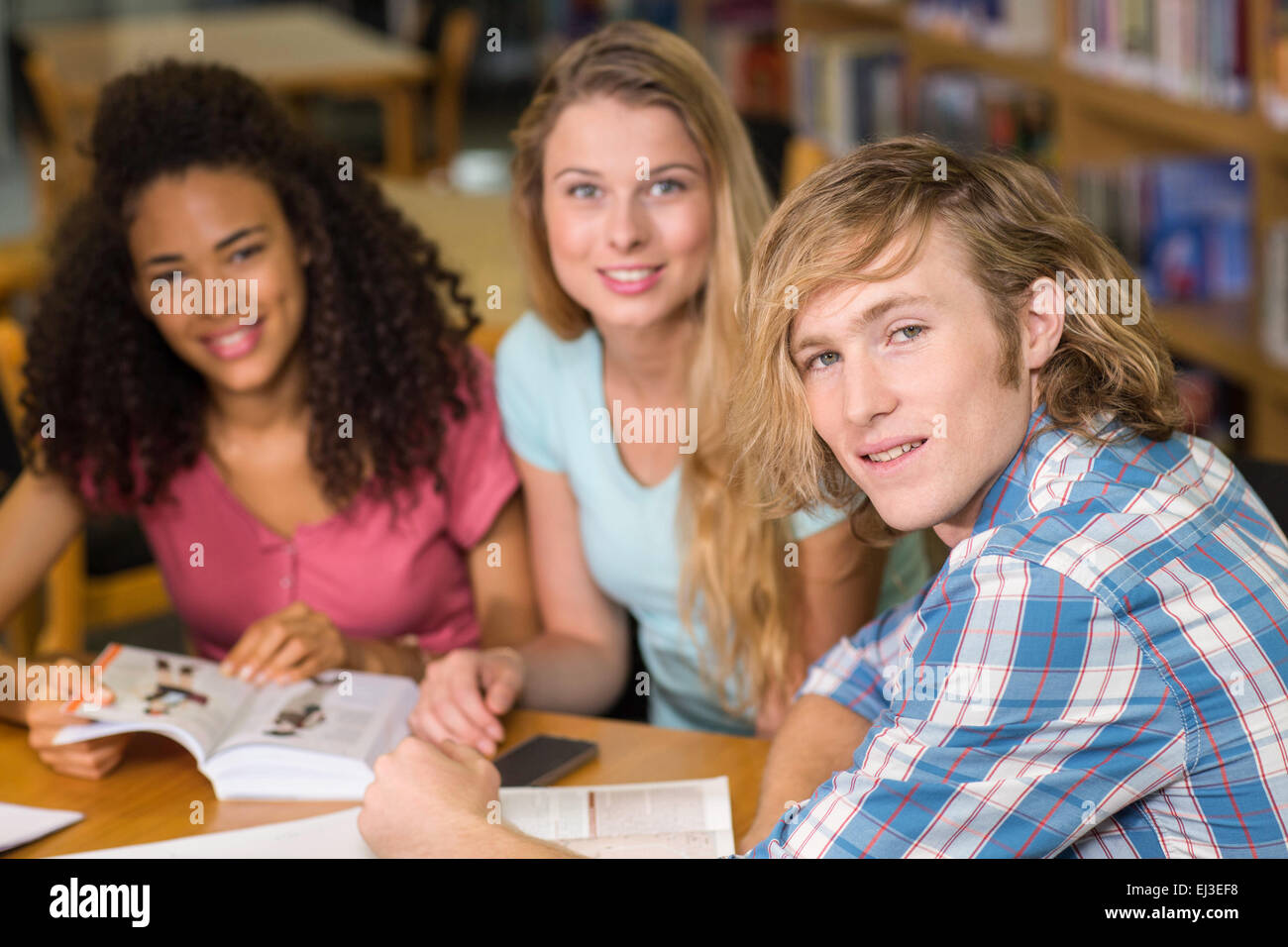 College students doing homework in library Stock Photo - Alamy