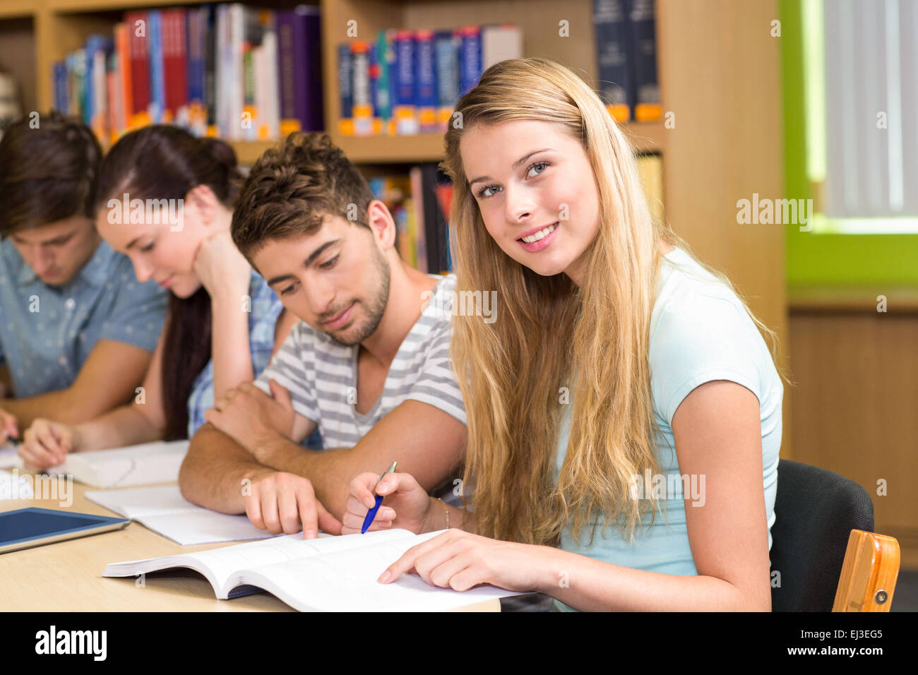 College students doing homework in library Stock Photo - Alamy