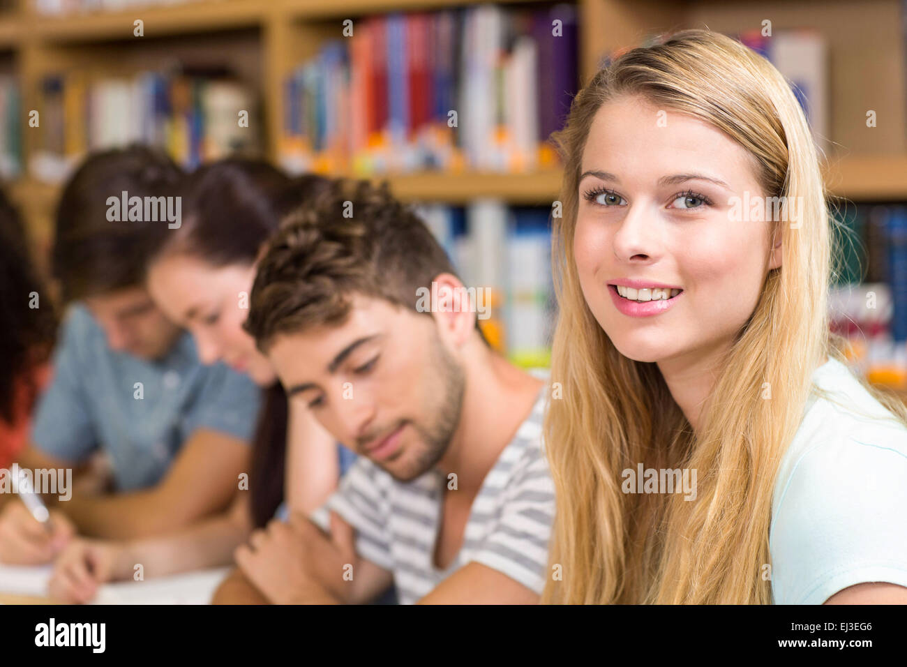 College students doing homework in library Stock Photo - Alamy