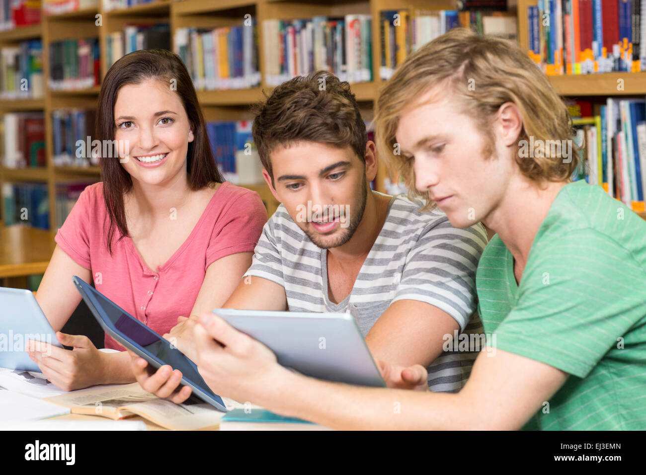 College students using digital tablets in library Stock Photo - Alamy