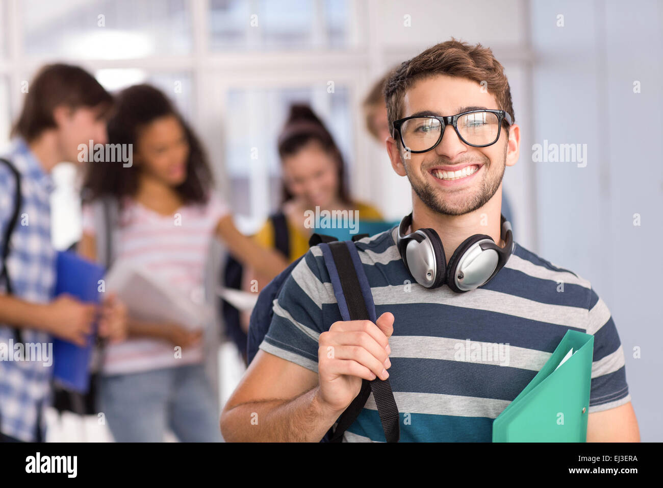 Male student holding folder in college Stock Photo - Alamy