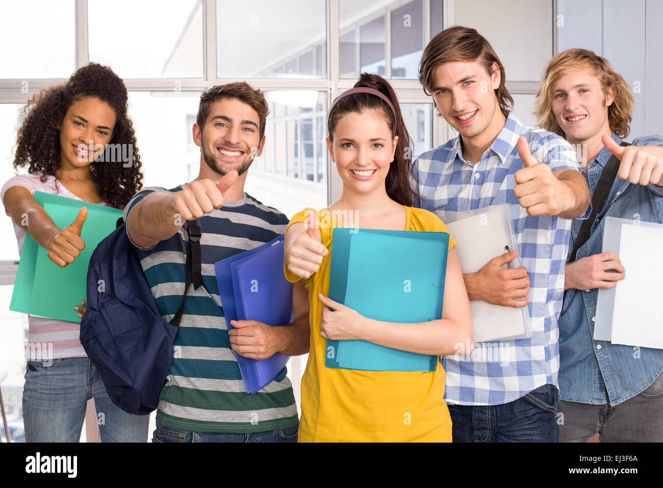 College students gesturing thumbs up Stock Photo - Alamy