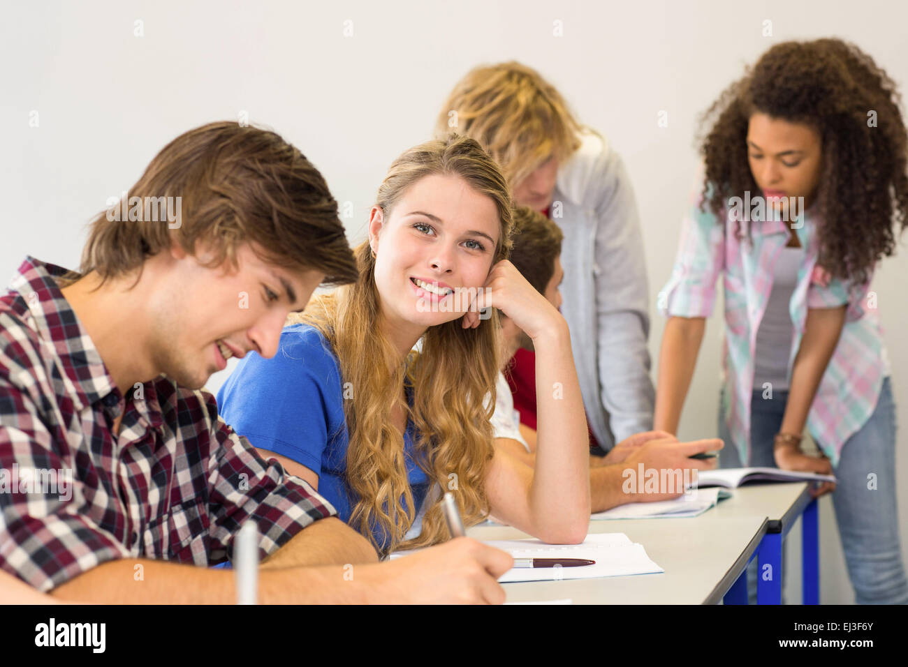 Students writing notes in classroom Stock Photo - Alamy