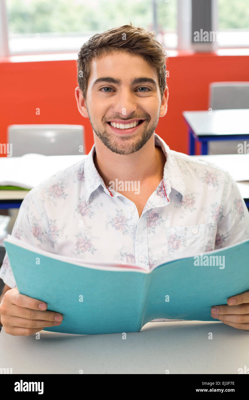 Male student reading notes in classroom Stock Photo - Alamy