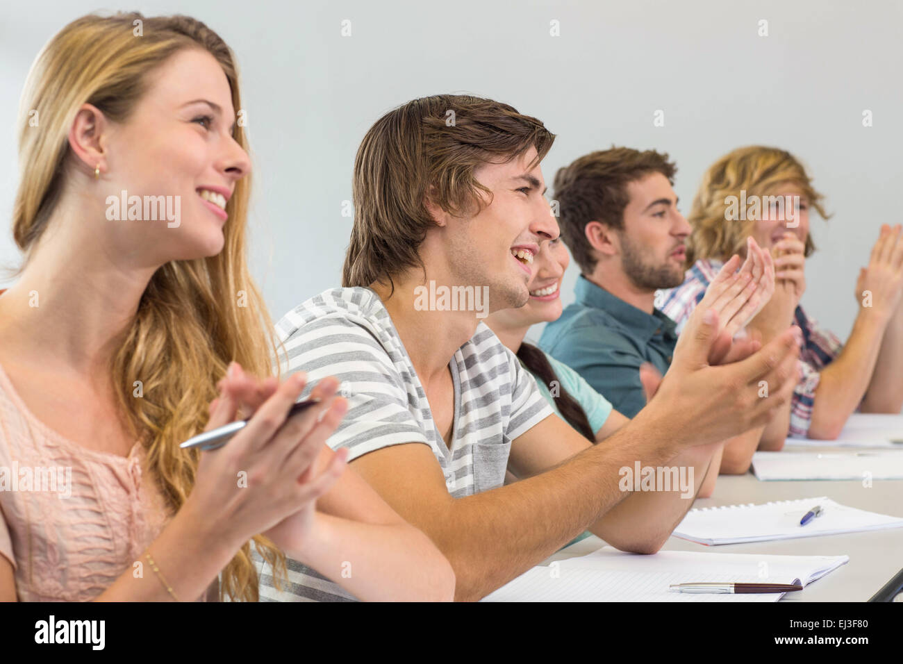 Students clapping hands in classroom Stock Photo - Alamy