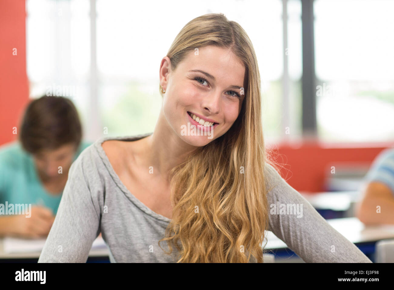 Smiling female student in classroom Stock Photo - Alamy