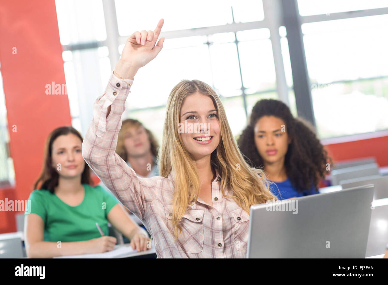 Female student raising hand hi-res stock photography and images - Alamy