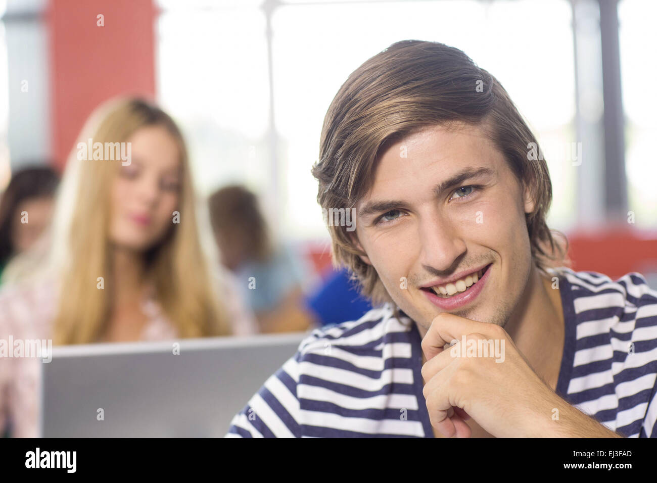 Smiling male student in classroom Stock Photo - Alamy