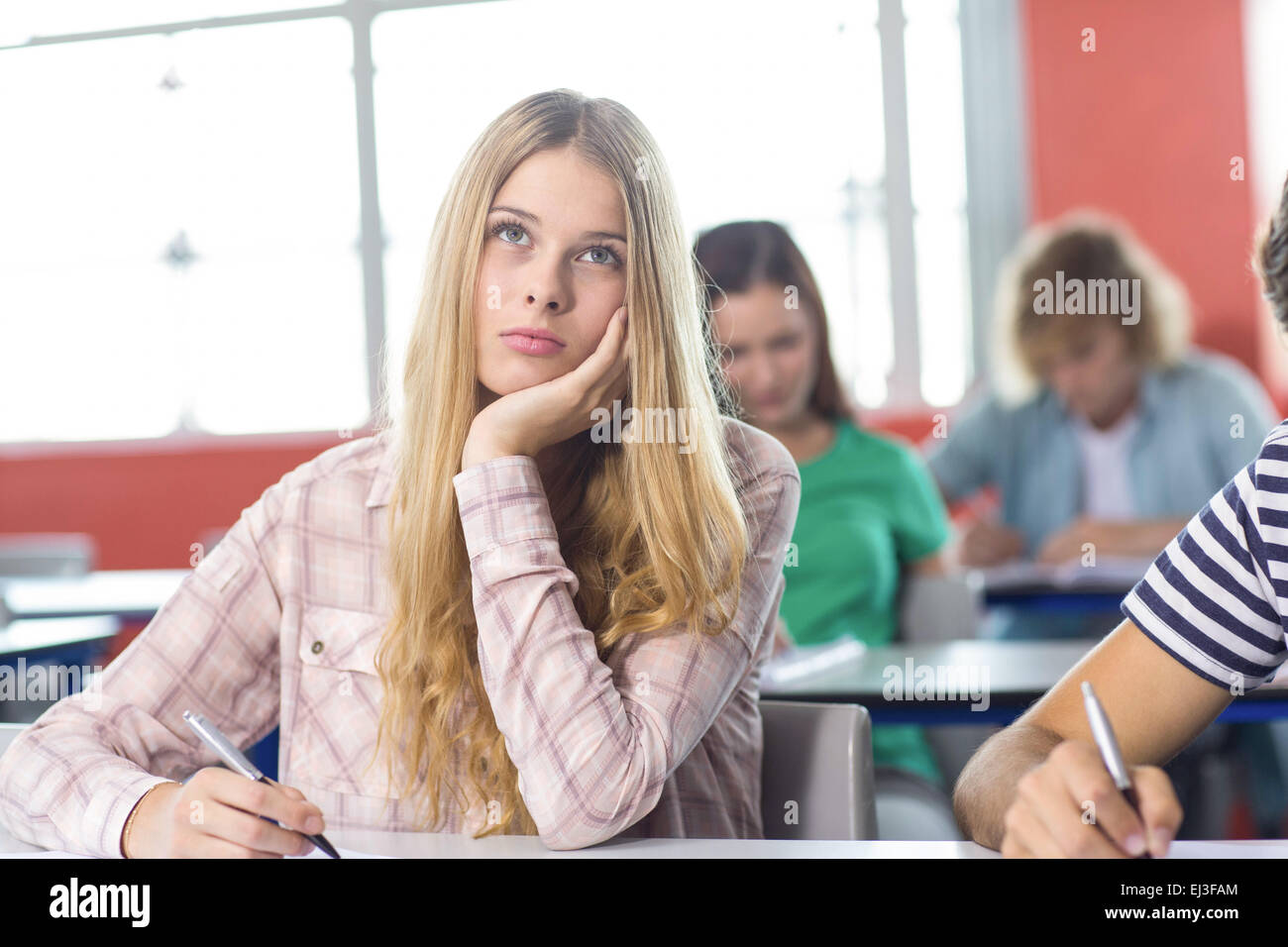 Thoughtful female student in classroom Stock Photo - Alamy